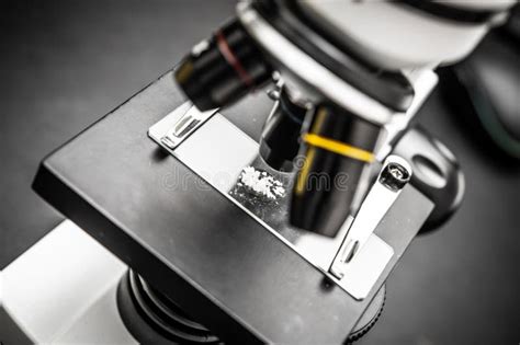Close Up Of Microscope Objective Lenses Focusing On A Slide With