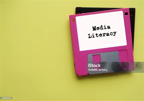 Pink Floppy Disk On Copy Space Yellow Background With Text Typed Media