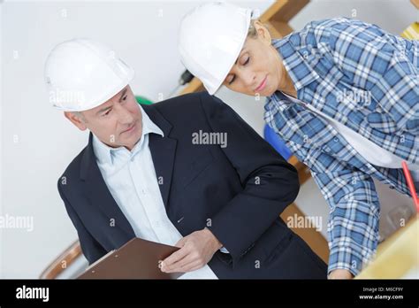 Male Architect Talking To Female Builder Stock Photo Alamy