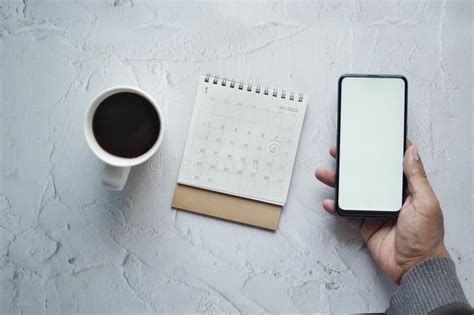 deadline concept with hand marking date on calendar and using smart