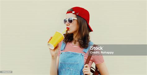 흰색 배경에 야구 모자를 쓰고 주스를 마시는 젊은 여성의 초상화 20 29세에 대한 스톡 사진 및 기타 이미지 20 29세 25 29세 거리 Istock