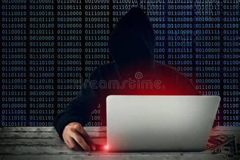 Hacker Wearing Black Hooded With Computer Hacking Data And Showing Money On Hand With Green
