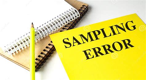 Sampling Error Text On A Yellow Paper Alongside Notebooks And A Yellow