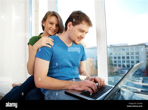Photo Of Man Typing On The Laptop And Woman Behind Stock Photo Alamy