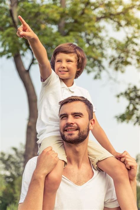Dad And Son Resting Outdoors Stock Image Image Of Green Laughing