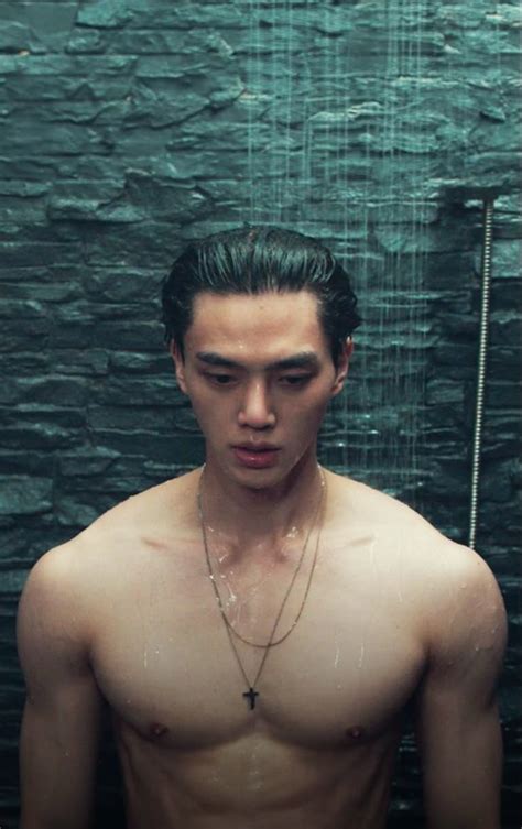 A Shirtless Young Man Standing In Front Of A Shower With Water Coming From The Faucet
