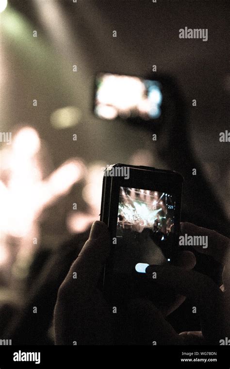 Concert Crowd Clapping In Front Of A Bright Stage Stock Photo Alamy