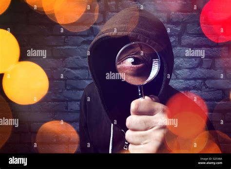 Hooded Computer Hacker With Magnifying Glass Internet Hacker And