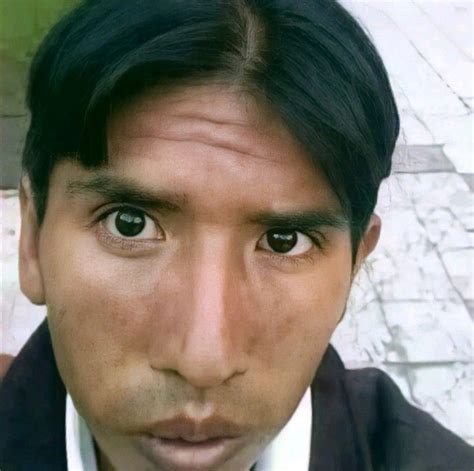 Close Up Of A Person With Wide Open Eyes In A Suit And Tie