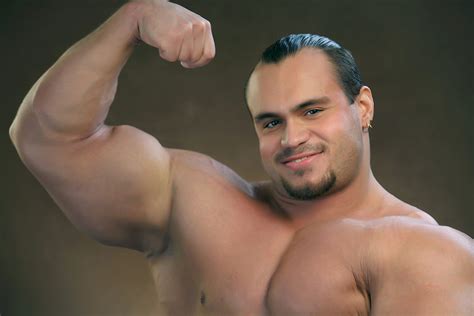 Male Bodybuilder Flexing Biceps Muscles High Quality Free Stock Images