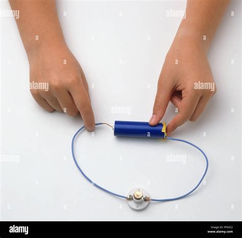 Girl S Hands Connecting Wire With Battery Making Simple Electric Curcuit Close Up Stock Photo