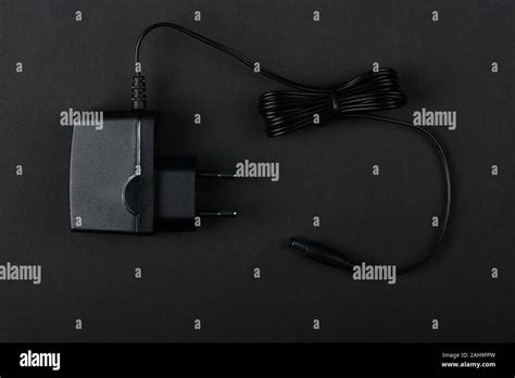 Black Power Ac To Dc Adaptor Power Adapter Of Router Isolated On Black Background High