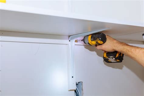 Premium Photo Man Installing Wooden Shelves On Brackets Wall