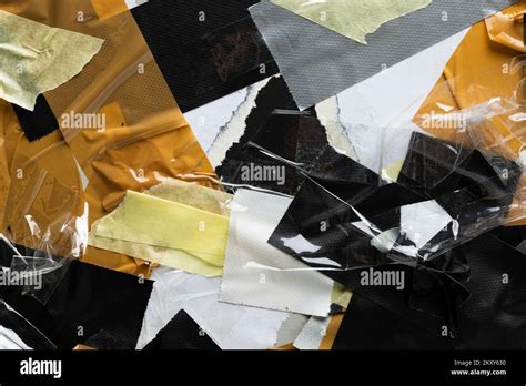 Collage Of Overlapping Pieces Of Black White Brow And Grey Masking Tape On Torn Paper Stock