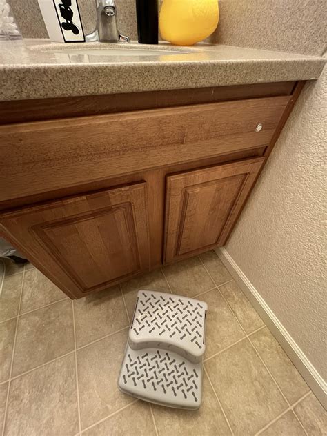 Half Inch Wide Pushable Button That Is Built Into The Bathroom Vanity