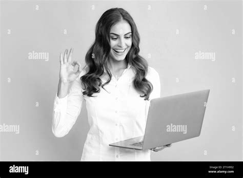 Beautiful Smiling Business Woman Over Grey Background Using Laptop