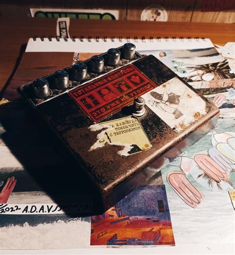 a close up of an old style guitar pedal on a table with pictures and ...