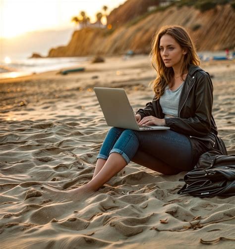 Woman Sitting In The Sand With Laptop Computer On Her Lap And Looking At The Camera Premium Ai