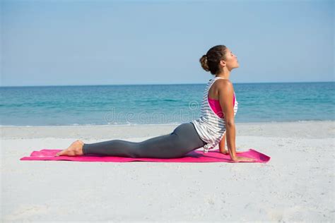Full Length Of Woman Practicing Cobra Pose At Beach Stock Image Image Of Meditation