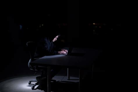 Hacker Using Laptop Computer While Working In Dark Office Stock Photo At Vecteezy