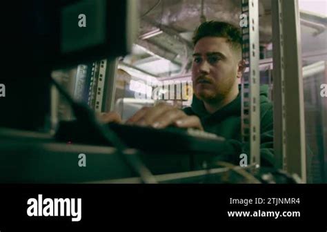 Focused Hacker Data Center Hacking Software System Vulnerable Cyber Security Server Room