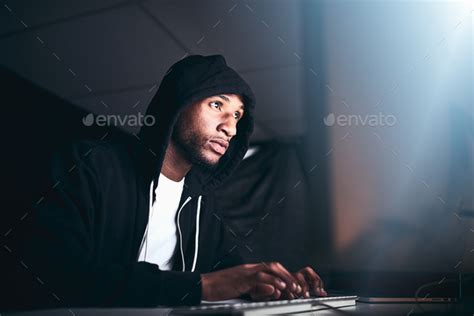 No Code Is Uncrackable Low Angle Shot Of A Young Male Hacker Cracking