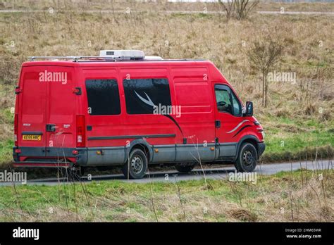 A Long Wheel Base Iveco Daily 355 23 Hpi Red Van Driving Along A