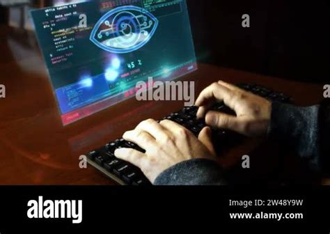 Hacker Typing On The Keyboard With Cyber Eye On Hologram Screen On Desk Hacking Control