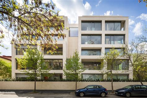 Stone Apartment Building In Bucharest Features Recessed Terraces