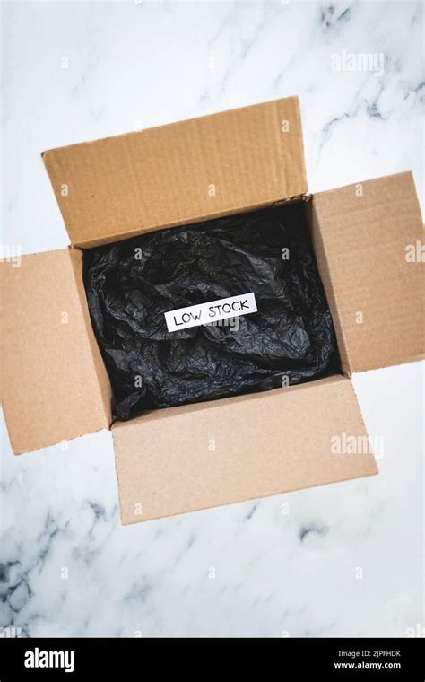 Low Stock Text Inside Of Empty Delivery Parcel With Black Padding On
