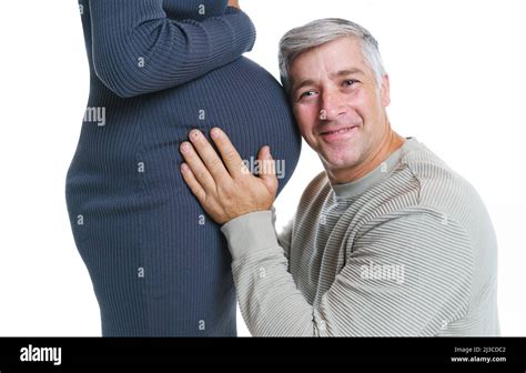 Happy Husband With Closed Eyes Listening To His Pregnant Wife Belly
