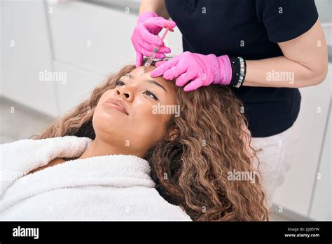 Young Woman Receives Botulinum Toxin Injections In A Cosmetology Clinic
