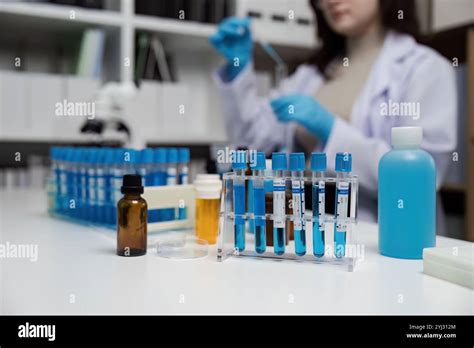 Modern Scientific Laboratory With Test Tubes And Researcher Conducting Experiments In A