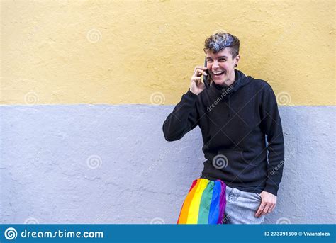 Non Binary Person With An Lgbt Rainbow Flag Talking On The Phone Outdoors Stock Photo Image