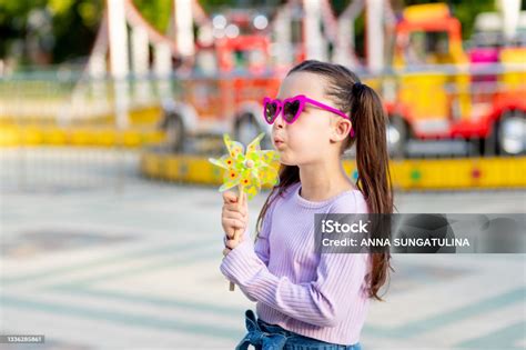 여름에 놀이 공원에서 어린 소녀는 선글라스 여름 휴가 및 방학의 개념에 회전 목마 근처 장난감 스피너에 불면 6 7 살에 대한 스톡 사진 및 기타 이미지 Istock