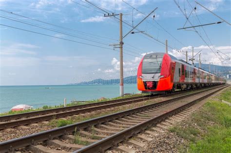 Red Train Rides On Rails Along The Editorial Stock Image Image Of Rail Cloud 315411579