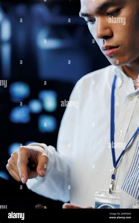 Engineer In Data Center Using Tablet To Prevent System Overload During