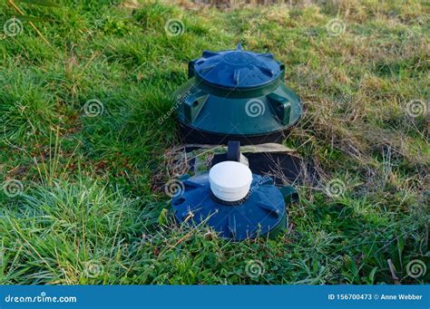 A Septic Tank Top Can Be Seen Above The Green Grass Stock Image Image