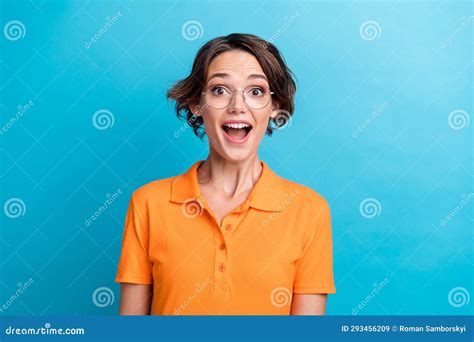 Photo Of Shocked Excited Lady Wear Orange T Shirt Spectacles Open Mouth Isolated Blue Color
