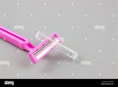 Pink Female Razor On Grey Background Removal Of Unwanted Hair Close Up Female Body Care