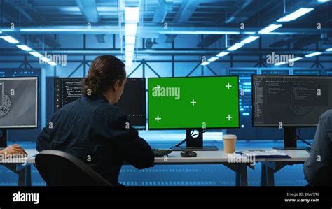 It Support Workers In Data Center Coding On Green Screen Computers