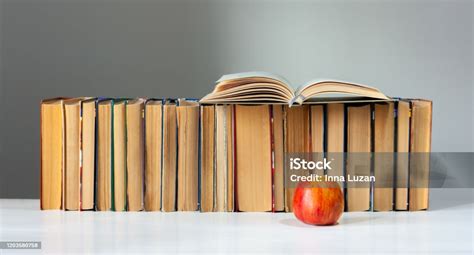 오픈 하드 백 책 일기 빨간 사과와 흰색 테이블에 책의 스택에 페이지를 부채질 책 스태킹 학교 개념으로 돌아갑니다 공간을 복사합니다 교육 학습 배경 0명에 대한 스톡 사진