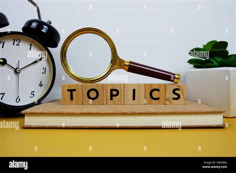 Magnifying Glass And Alarm Clock With Wooden Blocks Alphabet Letters Topics Text Message On