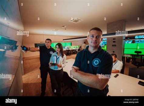 Group Of Security Data Center Operators Working In A Cctv Monitoring