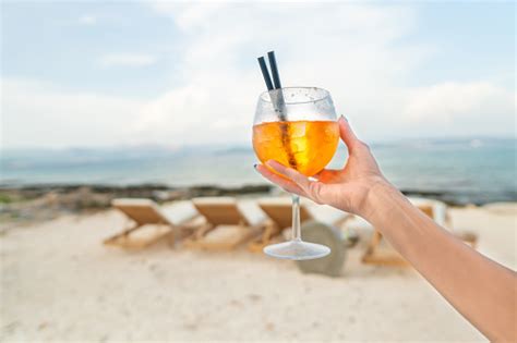 여름 햇살에 뜨거운 열대 해변에서 얼음 조각과 맛있는 클래식 아이스 아페롤 스프리츠 칵테일을 들고 여자 스프리츠에 대한 스톡 사진 및 기타 이미지 Istock