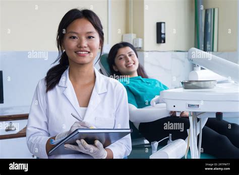 Asian Dentist Checking Up On Her Patient Female Dentist And Female
