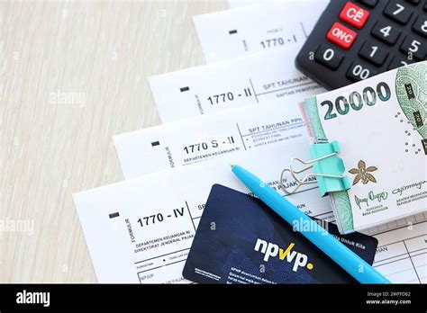 Annual Individual Income Tax Return Forms With Pen And Indonesian Rupiah Bills Original Name Is