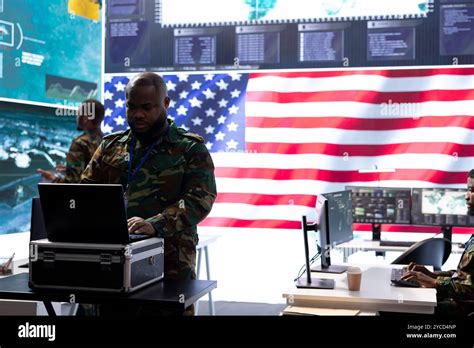 Military Professionals In A Command Center Monitor Global Cybersecurity Operations Managing