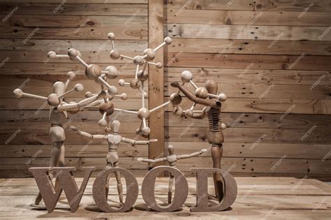 Premium Photo Close Up Of Wooden Figurines Holding Molecular Structure