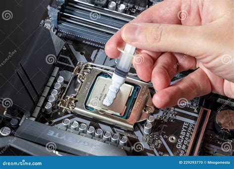 A Technician Applies White Thermal Paste To The Cpu Intel I7 9700k Installing A Cooler On A Pc